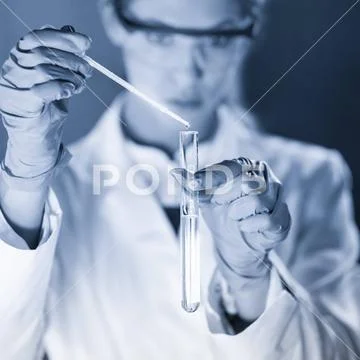Photograph: Young scientist pipetting in life science laboratory. Life ...