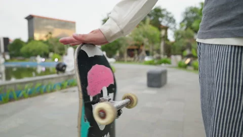 Young skater holding skateboard in hands... | Stock Video | Pond5