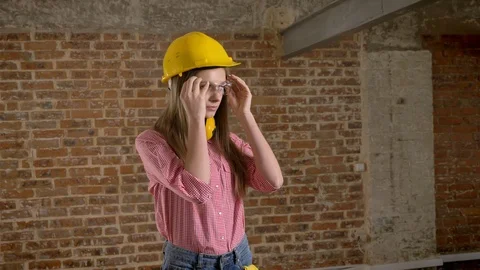 Young slim girl builder is wearing glase... | Stock Video | Pond5