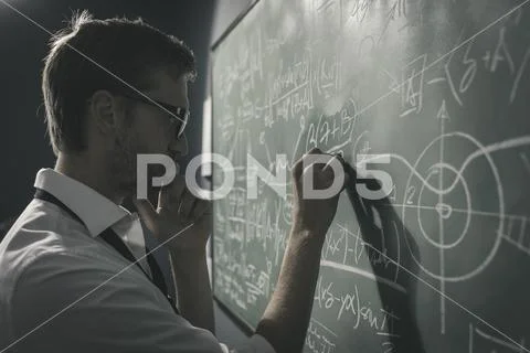 Young smart mathematician drawing on the chalkboard ~ Premium Photo ...