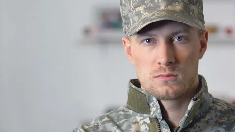 Young soldier looking camera closeup, mi... | Stock Video | Pond5