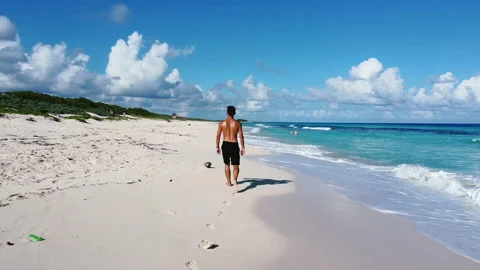 young tan man walking on empty white san... | Stock Video | Pond5