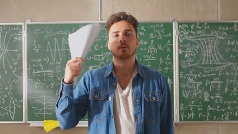 Young teacher fanning paper sheets in a ... | Stock Video | Pond5