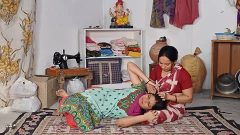 A young teenage girl is scratching her h... | Stock Video | Pond5