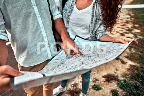 Young traveler and his girlfriend looking at a map ~ Hi Res #152483553
