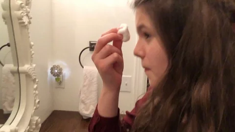 Young tween girl washing face in bathroo... | Stock Video | Pond5