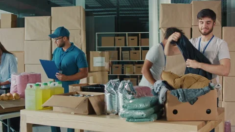 Young Volunteers People Sorting Goods fo... | Stock Video | Pond5
