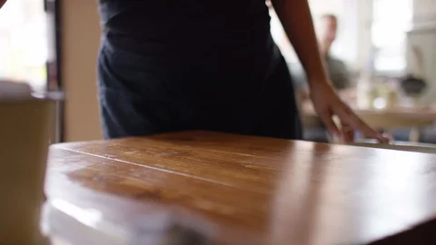 Young waitress wiping down a table in a ... | Stock Video | Pond5