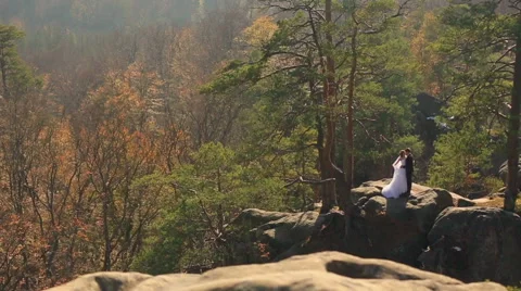 young wedding couple kissing on the moun... | Stock Video | Pond5