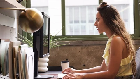 Young white woman using computer in an o... | Stock Video | Pond5