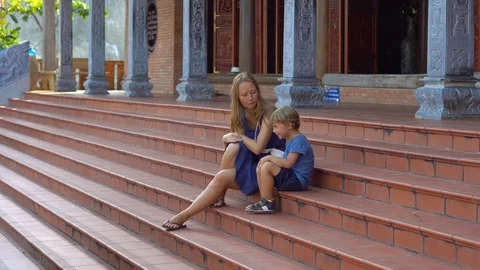 young woman and her son visiting a budhi... | Stock Video | Pond5