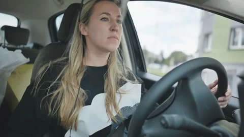 A young woman behind the wheel of a car ... | Stock Video | Pond5