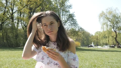Young Woman Brunette eating Sandwich Bur... | Stock Video | Pond5