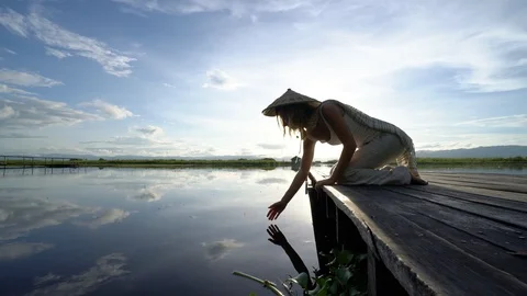 Young woman catching fresh water from la... | Stock Video | Pond5