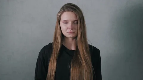 Young woman crying looking at the camera... | Stock Video | Pond5