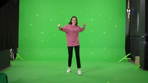 young woman dancing on green screen back... | Stock Video | Pond5