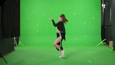 young woman dancing on green screen back... | Stock Video | Pond5