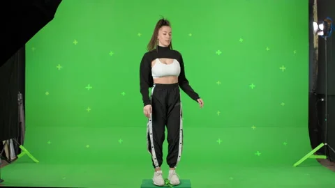 young woman dancing on green screen back... | Stock Video | Pond5