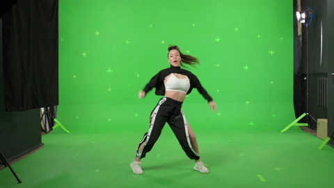 young woman dancing on green screen back... | Stock Video | Pond5