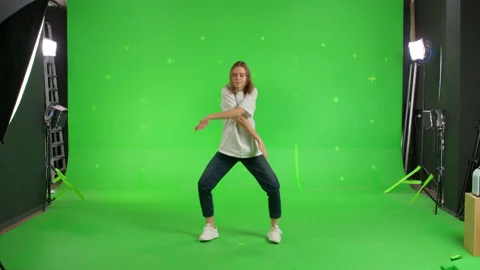 young woman dancing on green screen back... | Stock Video | Pond5