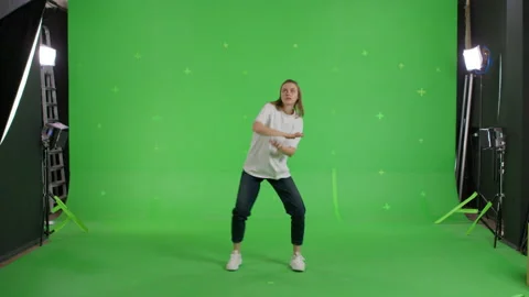 young woman dancing on green screen back... | Stock Video | Pond5