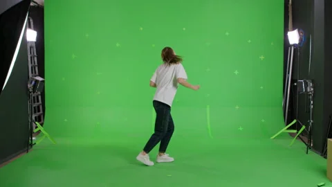 young woman dancing on green screen back... | Stock Video | Pond5