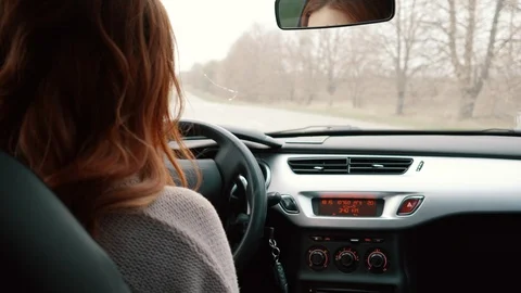 young woman driving a car, rear view | Stock Video | Pond5