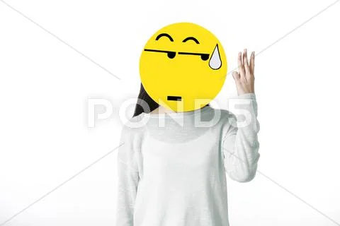 Young woman with a embarrassed emoticon face in front of her face Stock ...