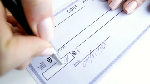 Young woman filling empty bank cheque. W... | Stock Video | Pond5
