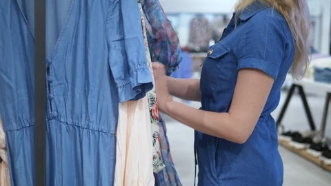 young woman finding new clothes in a bou... | Stock Video | Pond5