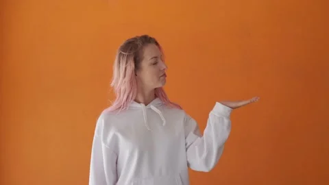 A young woman has two objects to choose ... | Stock Video | Pond5