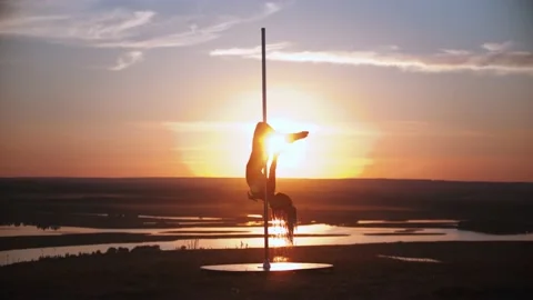 Young woman holding by the dancing pole ... | Stock Video | Pond5