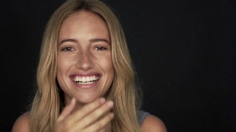 Young woman laughing and covering mouth | Stock Video | Pond5