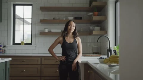 Young Woman Leaning Against a Counter To... | Stock Video | Pond5
