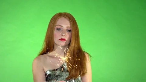 A young woman with long ginger hair hold... | Stock Video | Pond5