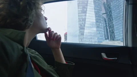 Young woman look out of car window on ci... | Stock Video | Pond5