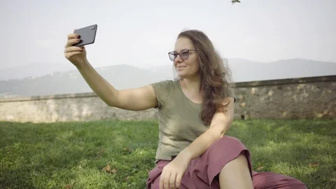 Young woman making selfie while seating ... | Stock Video | Pond5