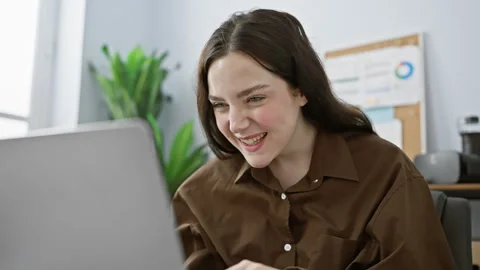 A young woman in an office setting stick... | Stock Video | Pond5