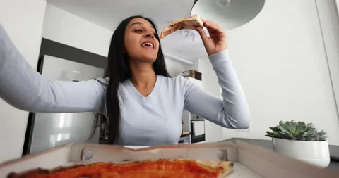 Young woman opening pizza box biting int... | Stock Video | Pond5