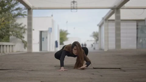 Young woman outdoors moves on all fours ... | Stock Video | Pond5