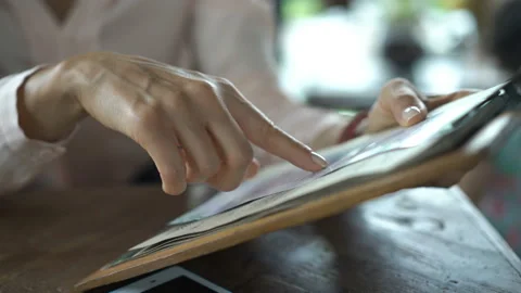 Young woman reading menu sitting in cafe... | Stock Video | Pond5