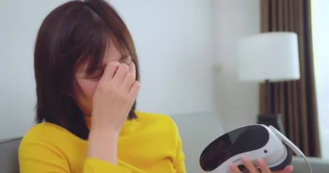 Young woman remove VR on her head and fe... | Stock Video | Pond5