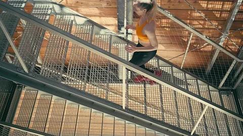 Young woman runner, jump on up the stair... | Stock Video | Pond5