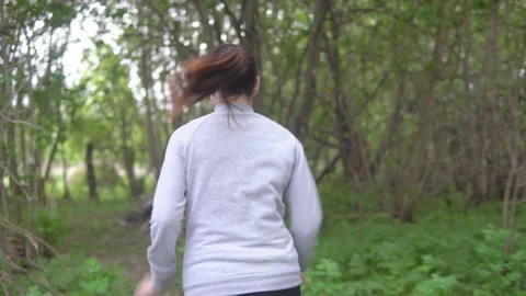 Young woman running through the woods, l... | Stock Video | Pond5