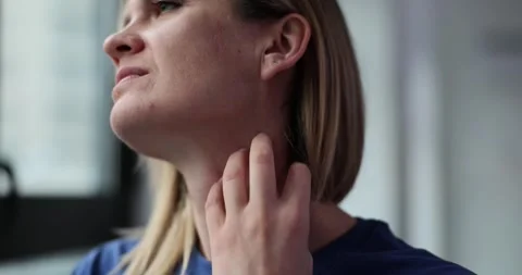 Young woman scratches itchy chest and ne... | Stock Video | Pond5