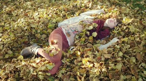A young woman sleeping on a pile of dead... | Stock Video | Pond5