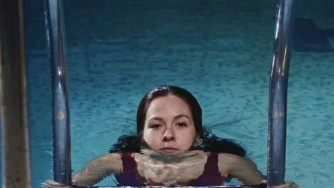 Young woman swimmer in red swimsuit stan... | Stock Video | Pond5