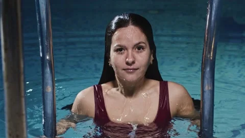 Young woman swimmer in red swimsuit come... | Stock Video | Pond5