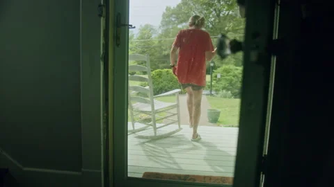 Young woman walking out her front door t... | Stock Video | Pond5