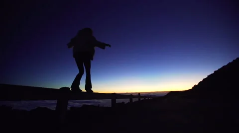 Young Woman Walking into Sunset Balancin... | Stock Video | Pond5